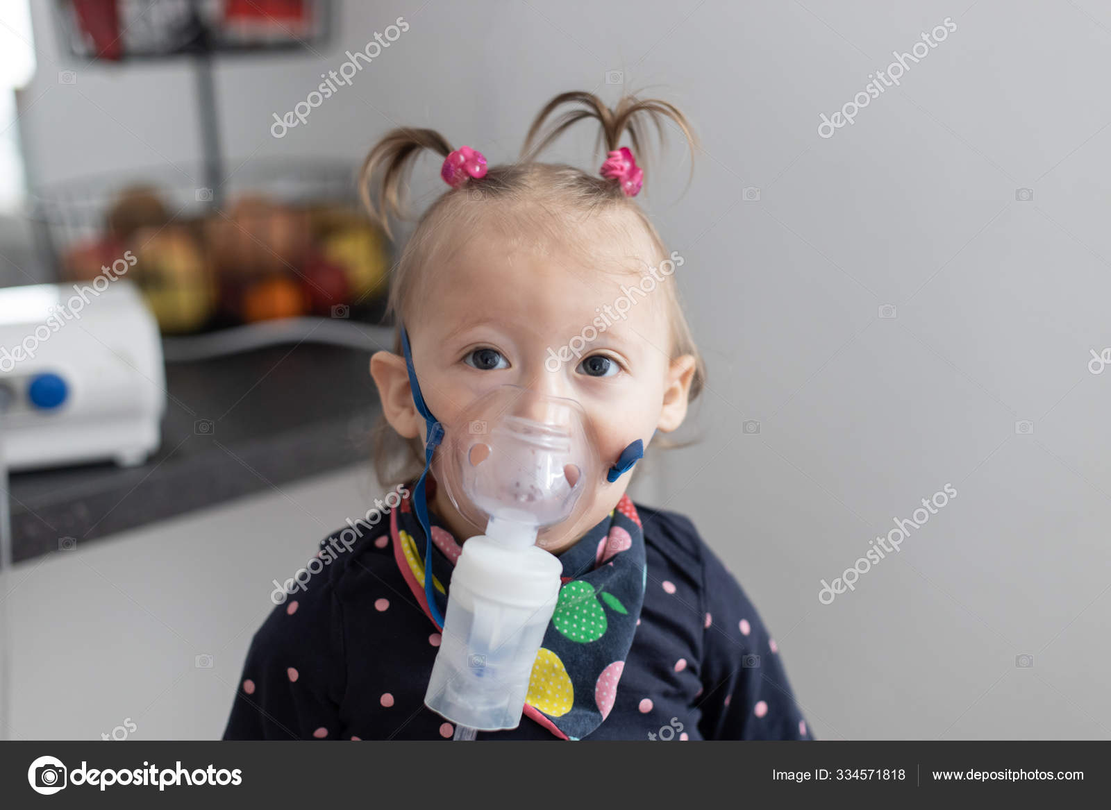 Cute little baby in the mask of an inhaler. Procedure of inhalation at ...