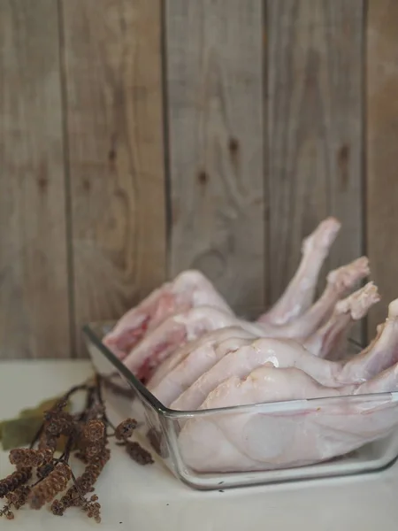 Carcass of raw rabbit meat on a glass baking sheet. Home cooking, cook ...