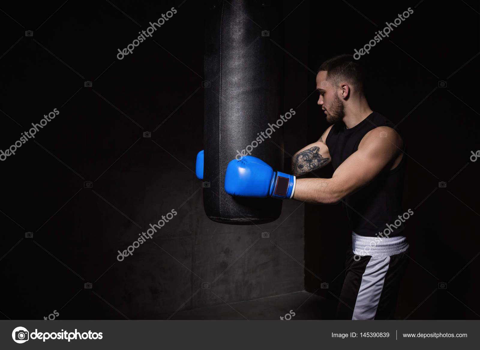 Athlete boxer man punching a punching bag Stock Photo by ©cellar-door ...