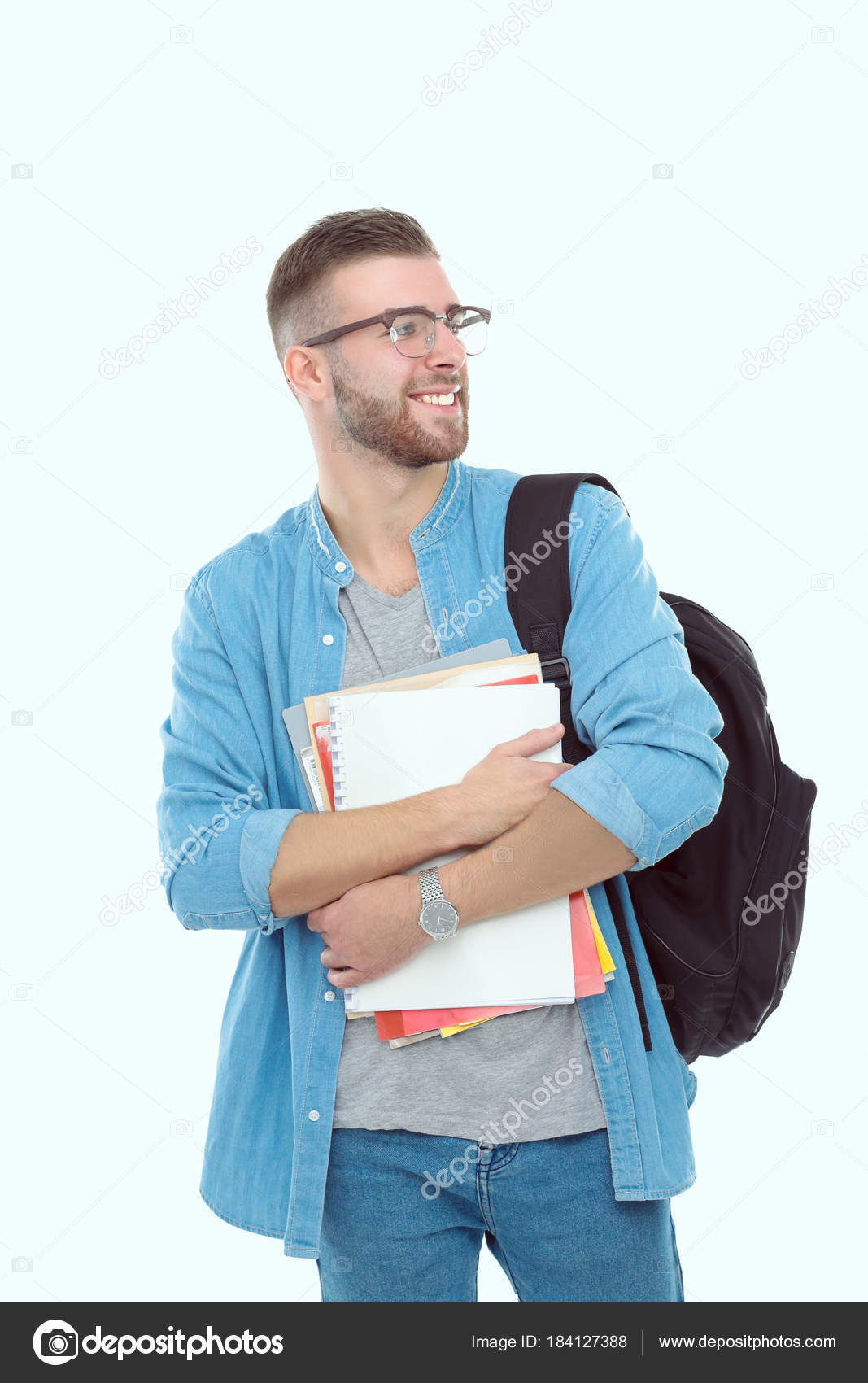 A male student with a school bag holding books isolated on white ...