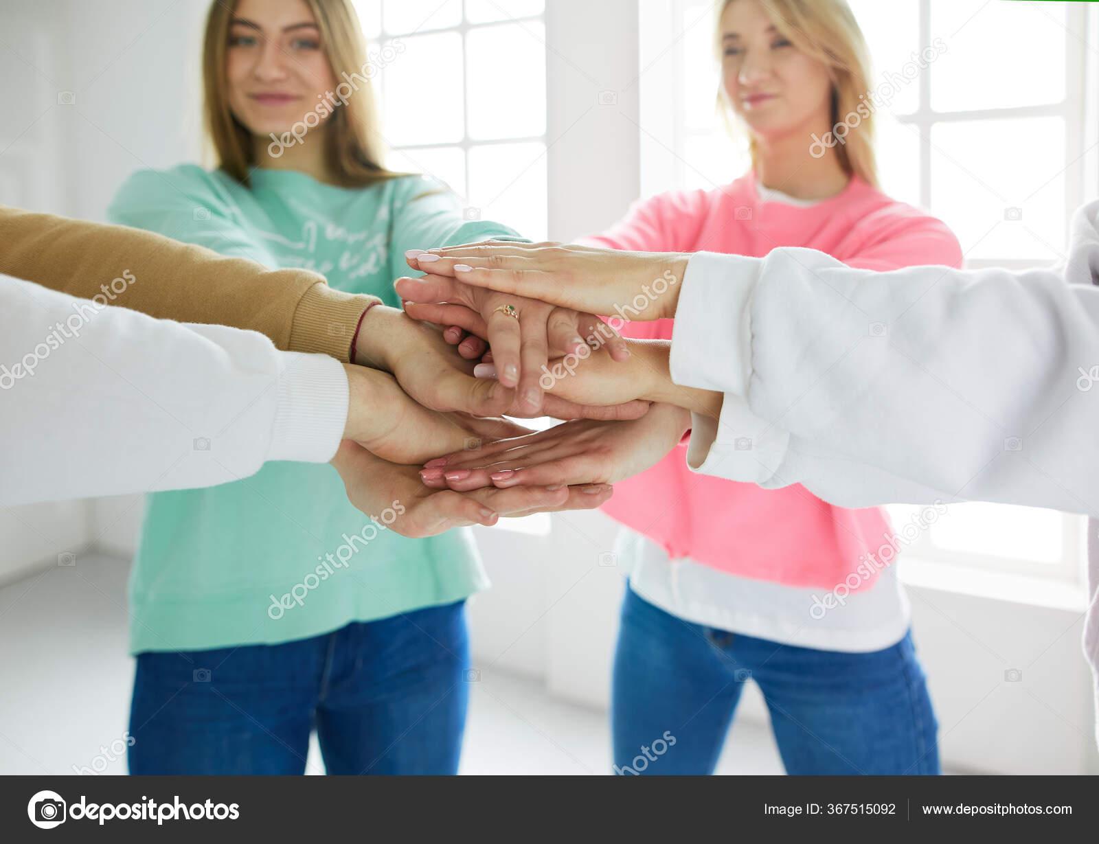 People joining hands, young women standing together Stock Photo by ...