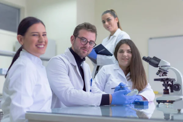 Group of Laboratory scientists working at lab with test tubes, - Stock ...