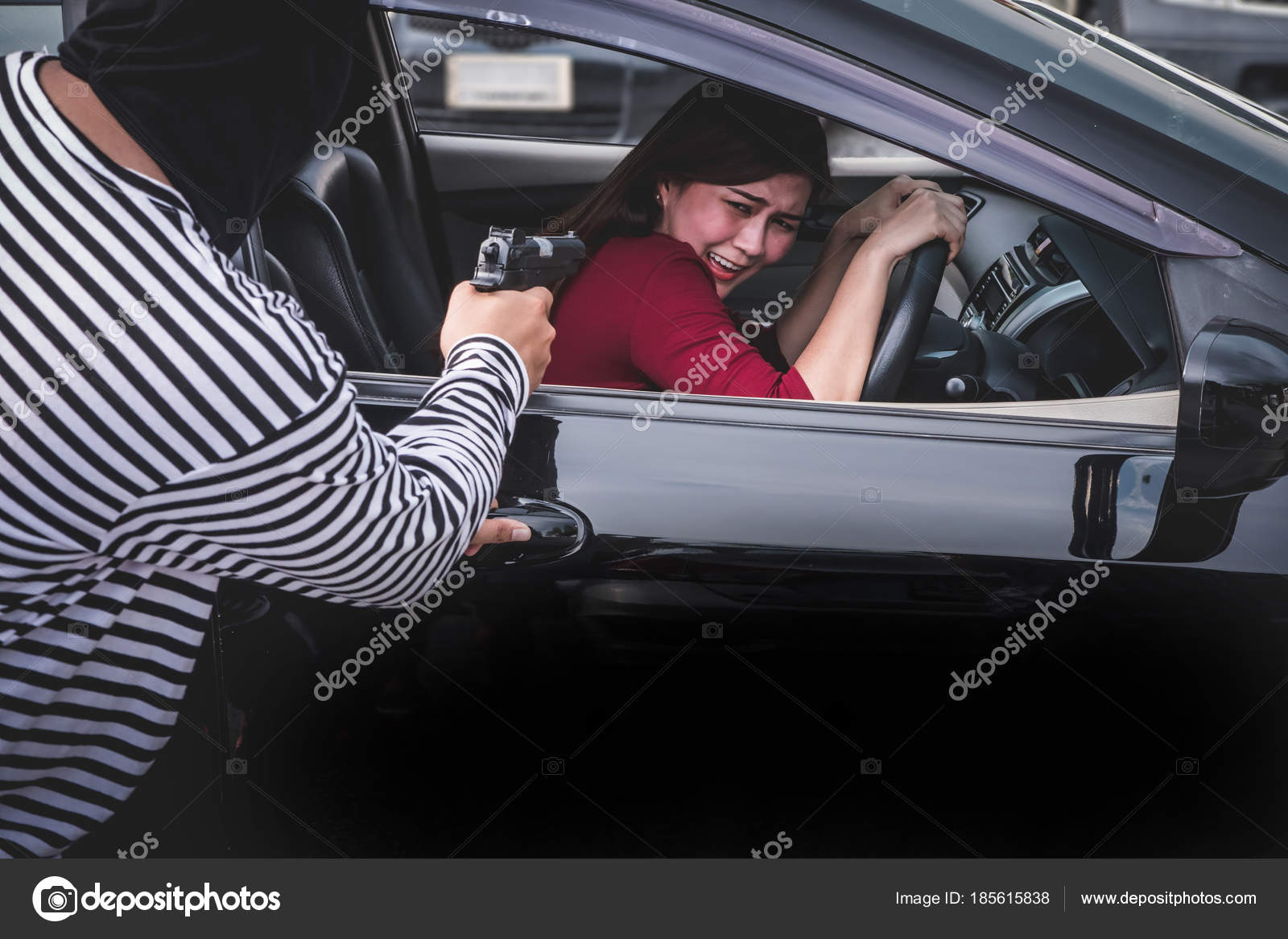 Robber pointing a gun to scare young woman and try to rob her car ...