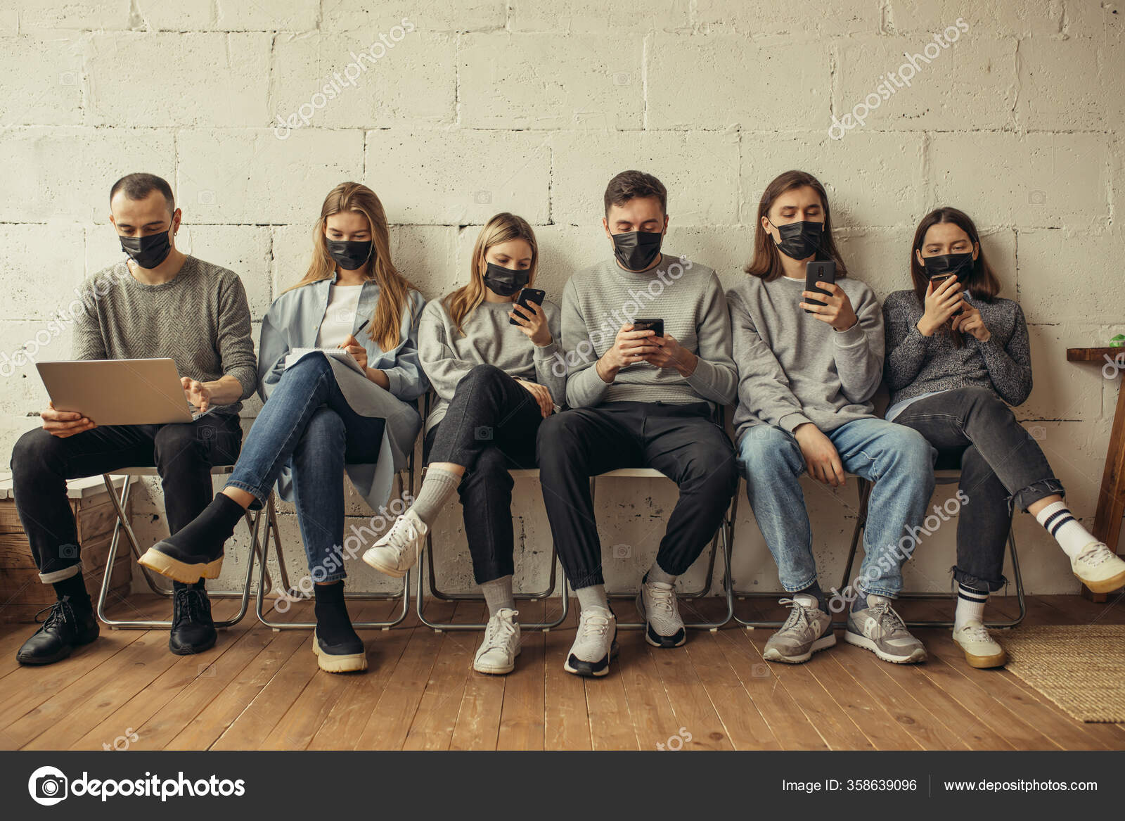 Young people sit together in masks Stock Photo by ©romanchazov27 358639096
