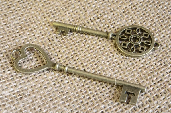 Two ancient keys from bronze on burlap. - Stock Image - Everypixel
