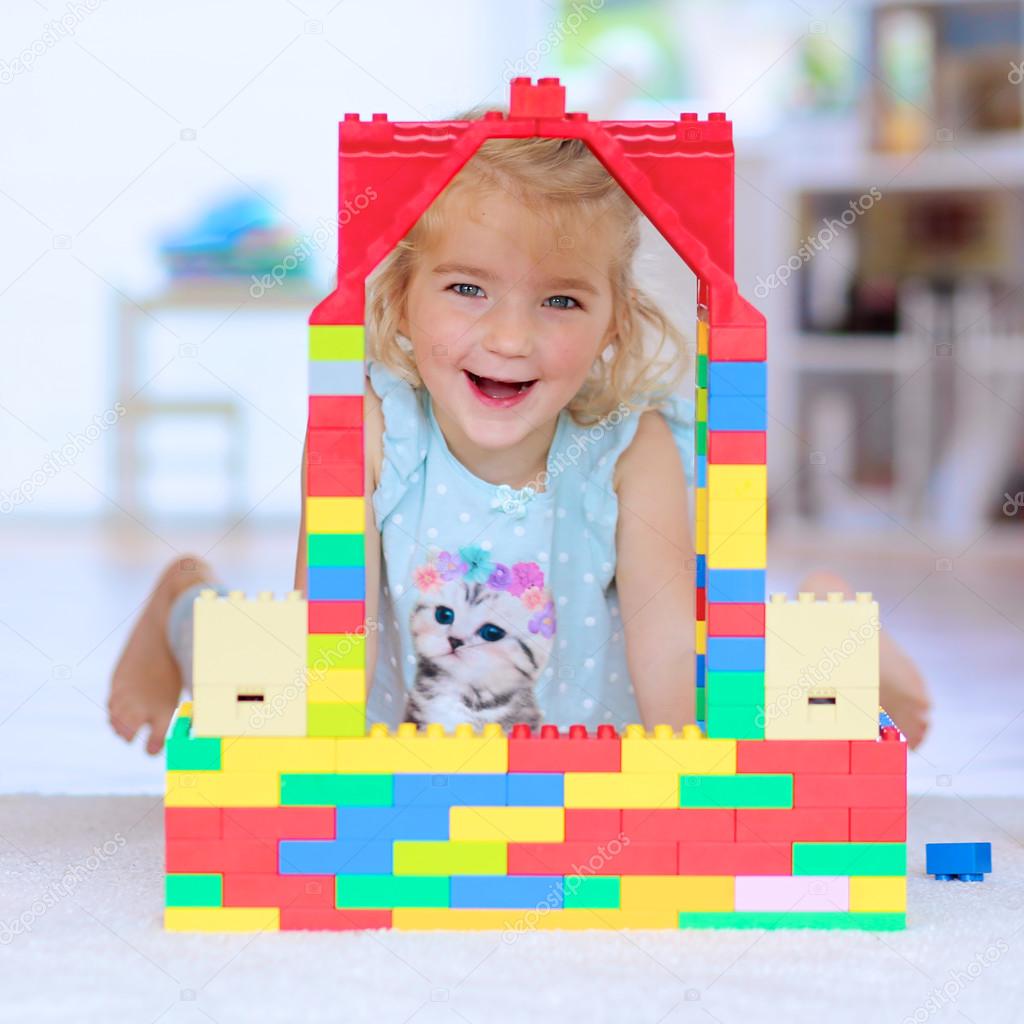 Little girl playing with construction bricks indoors — Stock Photo ...