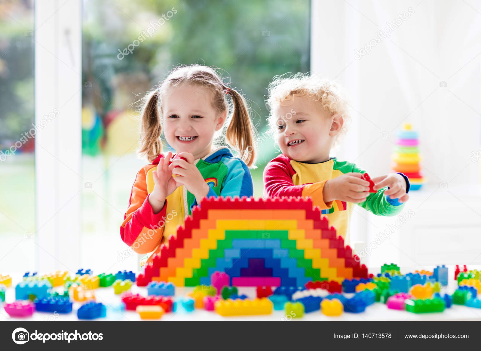 Kids playing with colorful blocks Stock Photo by ©FamVeldman 140713578