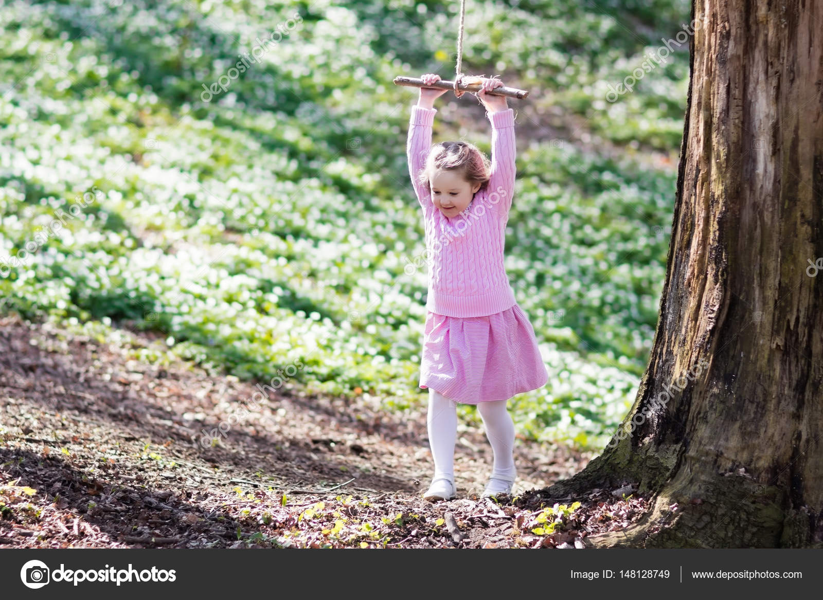 Child swinging on tree rope swing Stock Photo by ©FamVeldman 148128749