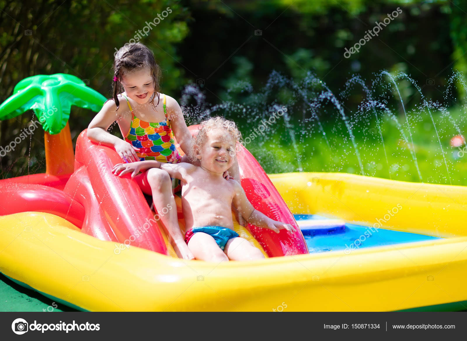 Kids playing in inflatable pool Stock Photo by ©FamVeldman 150871334