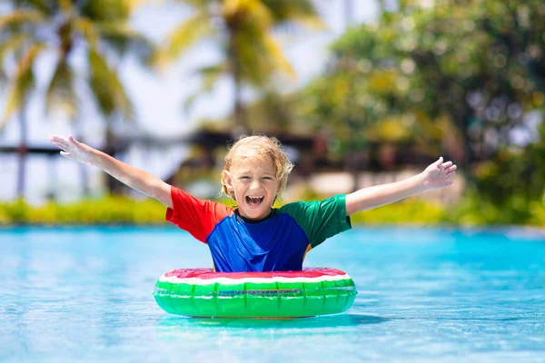 Child in swimming pool on donut float Stock Photo by ©FamVeldman 302137950