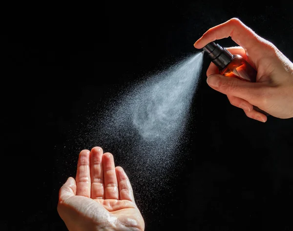 Woman's hands spray an antiseptic to protect against the virus ...