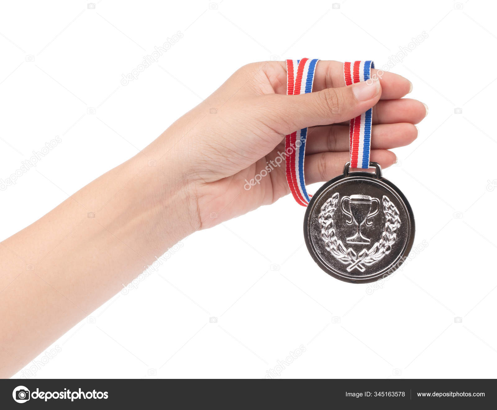 Winner hand raised and holding silver award medal with ribbon is ...