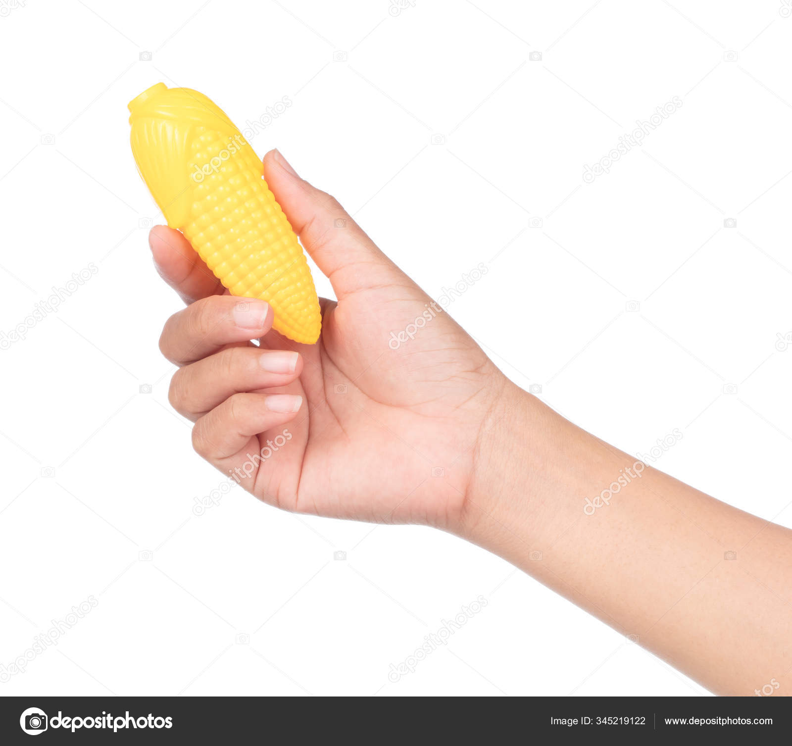 Hand holding plastic toy corn isolated on white background — Stock ...