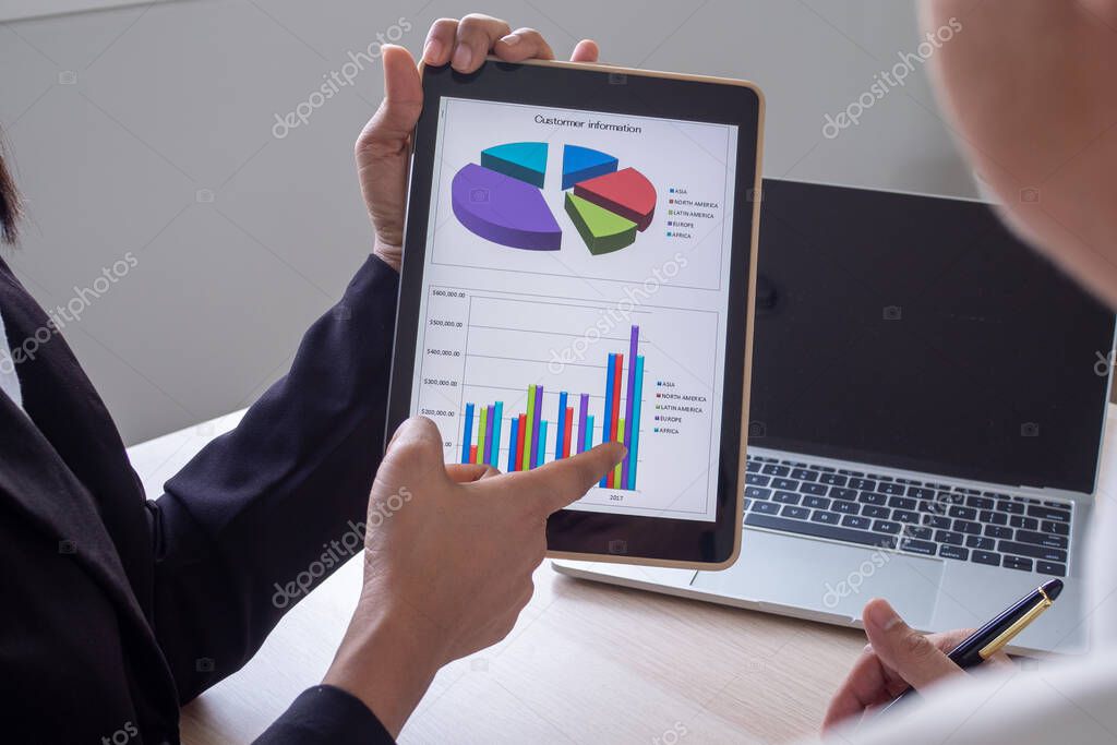 Los hombres de negocios están hablando de gráficos o estadísticas de ...