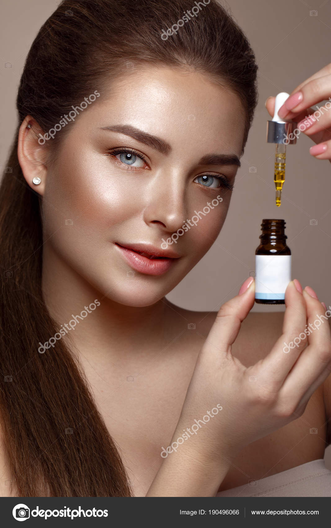 Beautiful Young Girl With Natural Nude Make Up With Cosmetic In Hands