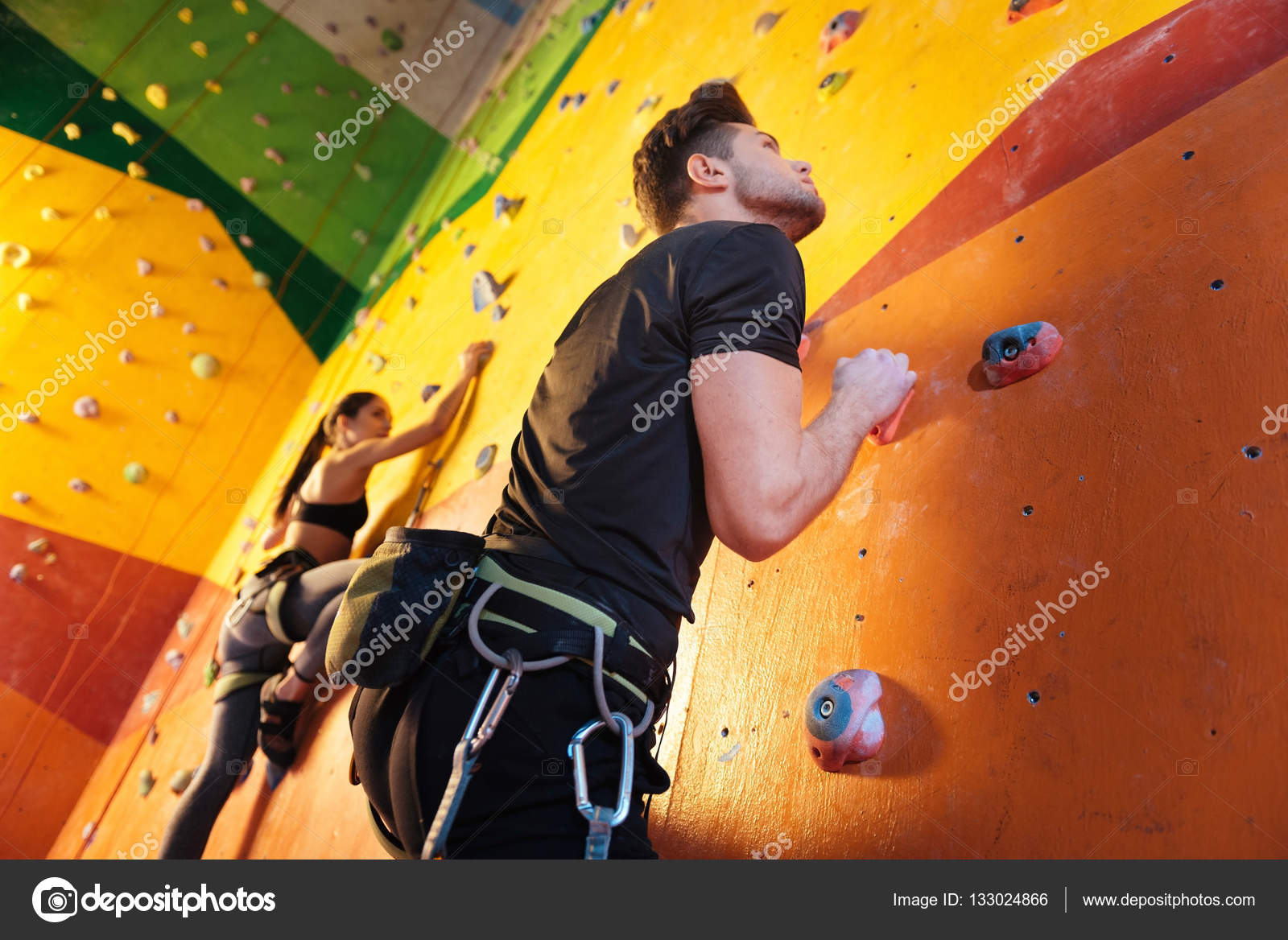 Delighted couple climbing up the wall. — Stock Photo © yacobchuk1 #133024866