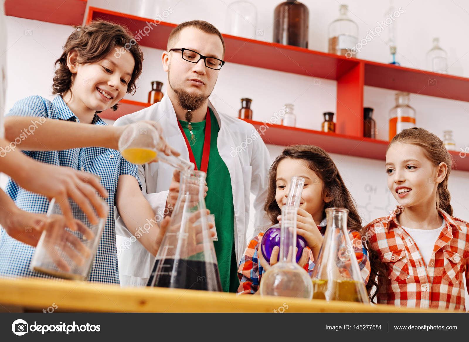 Children conducting experiment Stock Photo by ©yacobchuk1 145277581