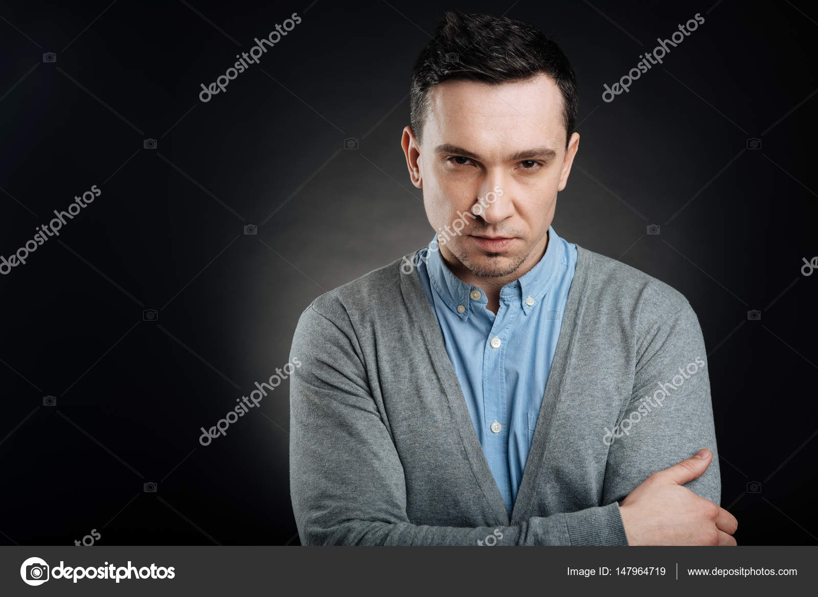 Suspicious young man looking angrily on camera Stock Photo by ...