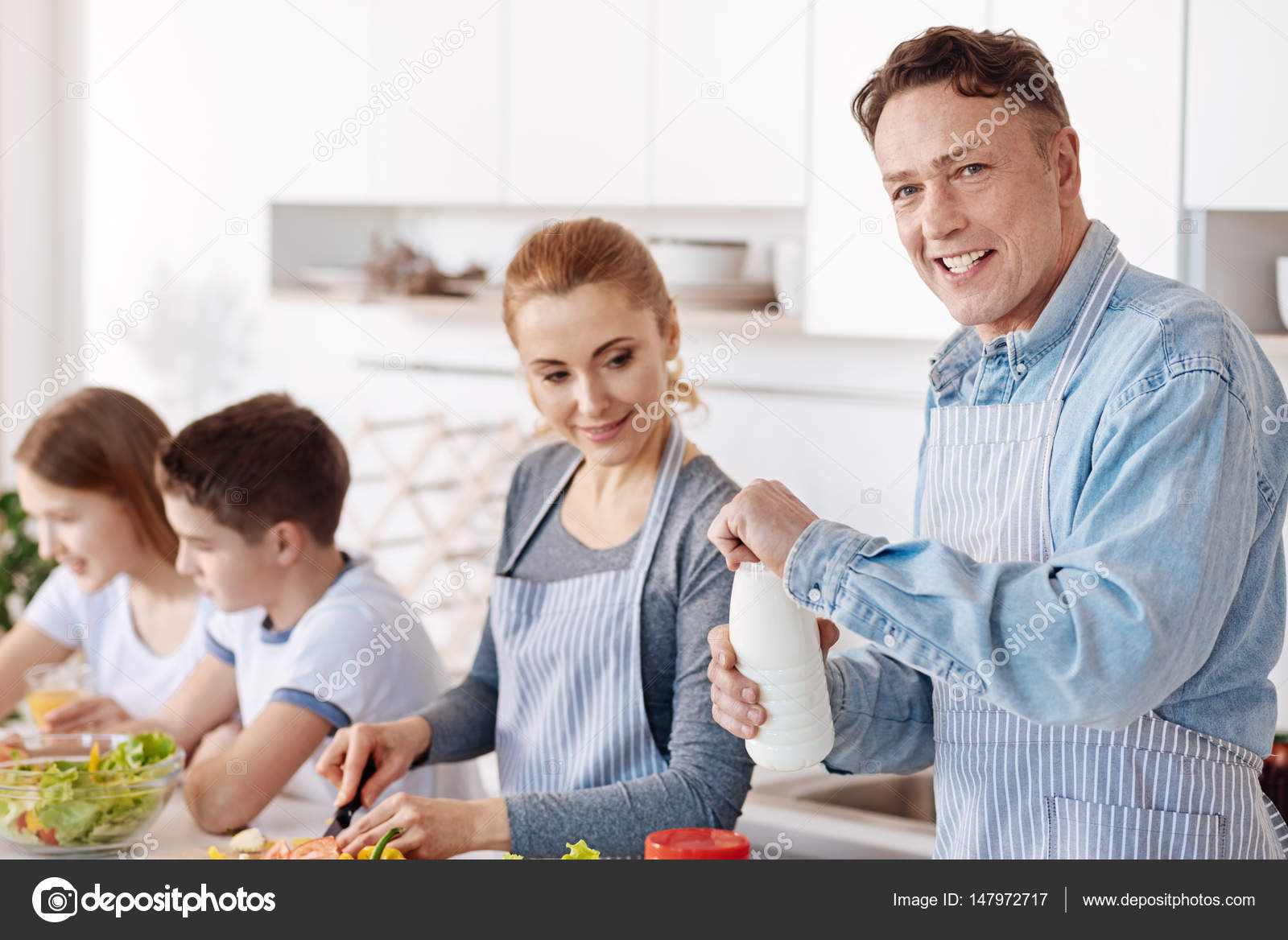 Positive loving family cooking dinner together Stock Photo by ...
