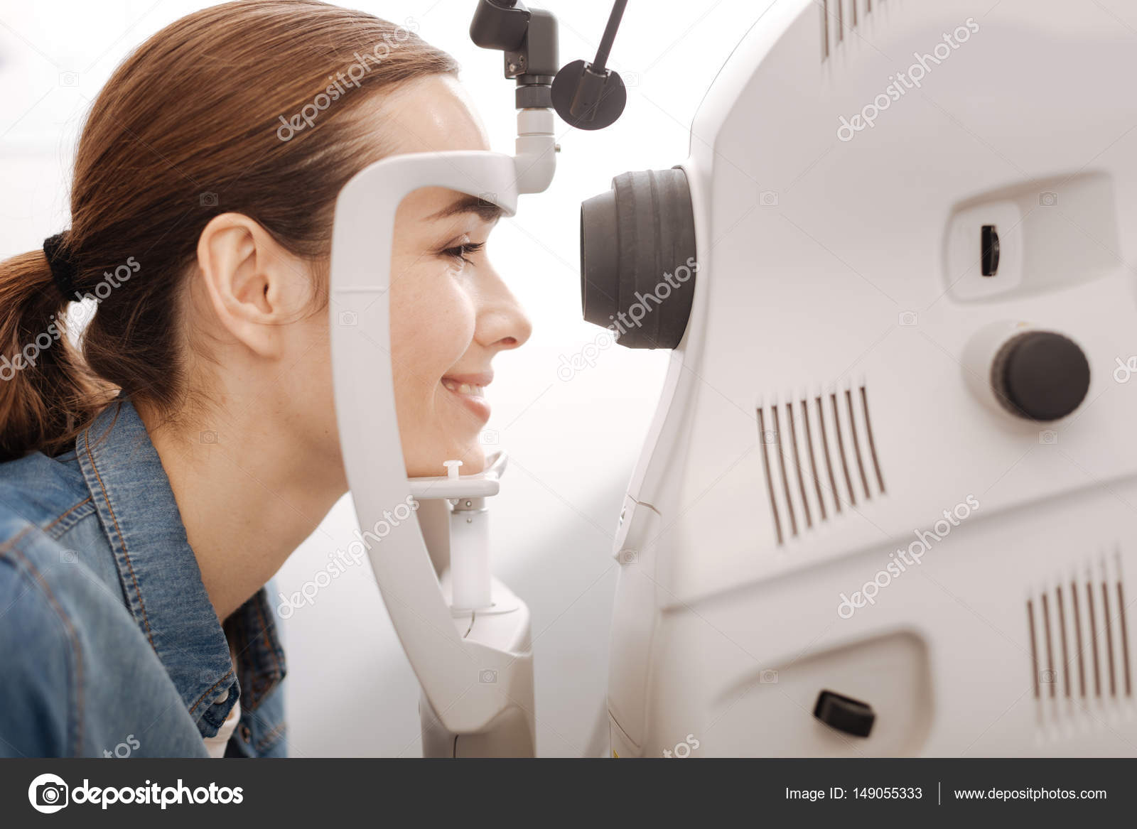 Cheerful female patient having her vision checked Stock Photo by ...