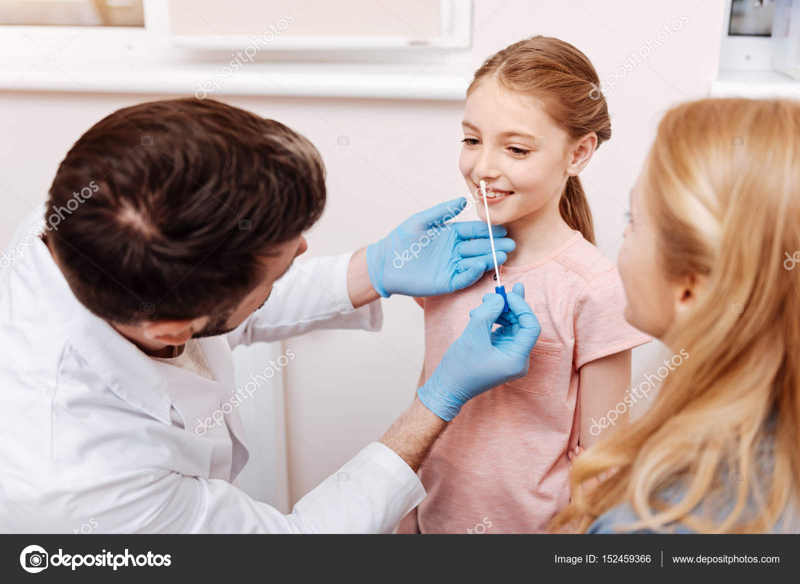Experienced family doctor doing nose exam — Stock Photo © yacobchuk1 ...