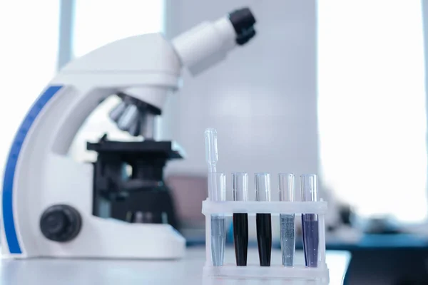 Microscope and test tubes in laboratory Stock Photo by ©AndreyBezuglov ...
