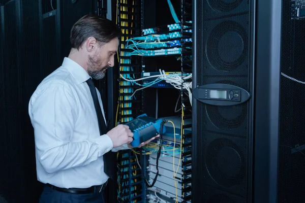 Professional handsome engineer doing a system check - Stock Image ...