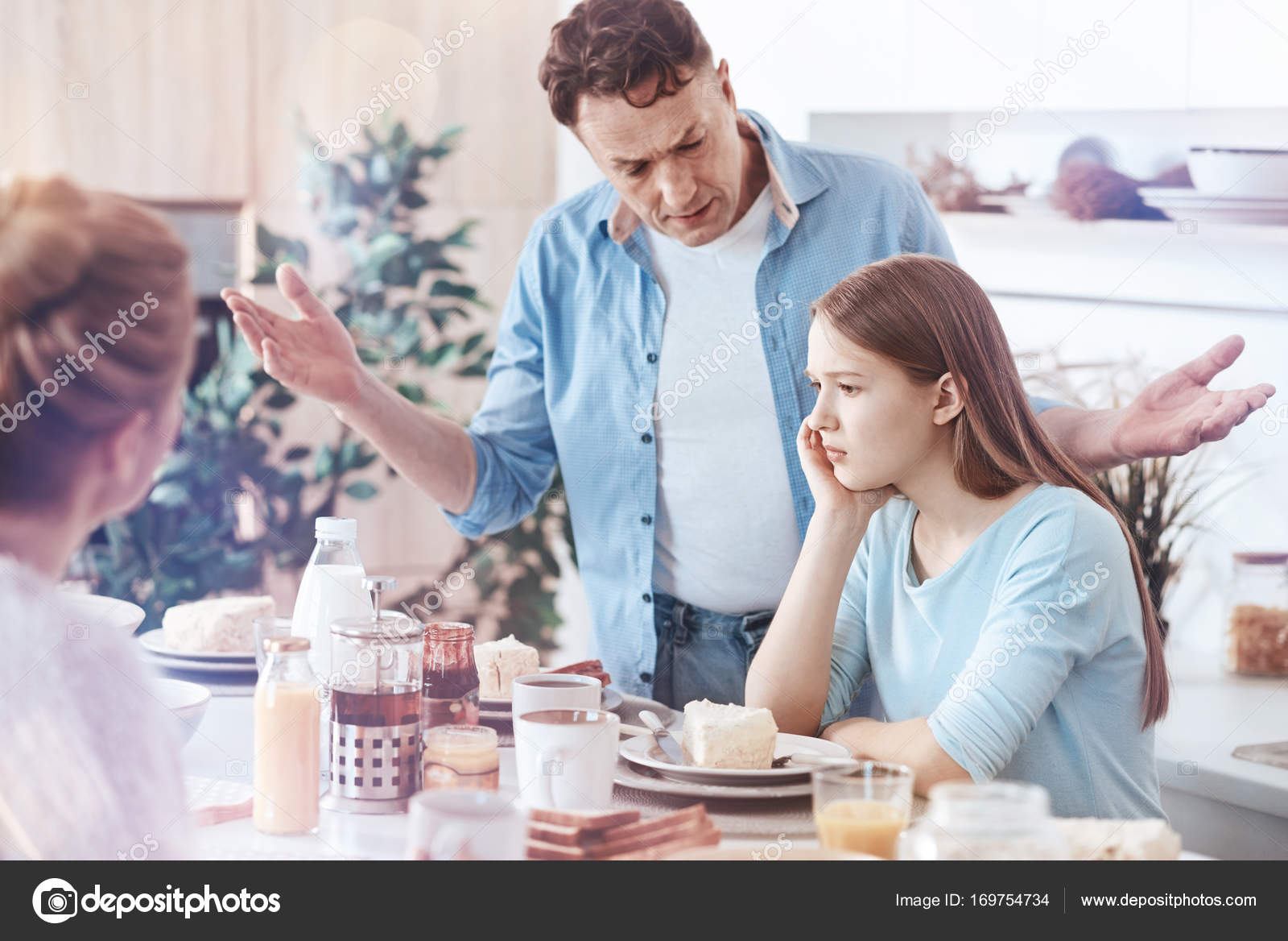 Concerned father getting emotional while yelling his teenage daughter ...