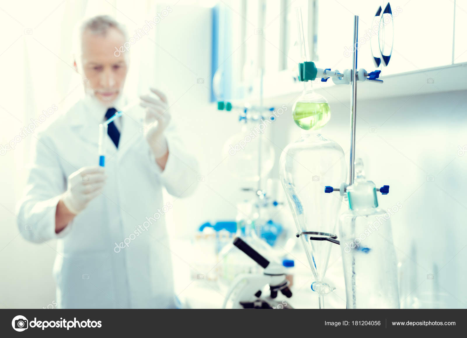 Male lab worker conducting chemical experiment Stock Photo by ...