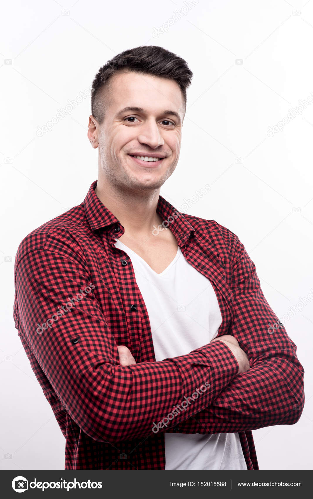 Charming man standing half-turned and folding his arms Stock Photo by ...