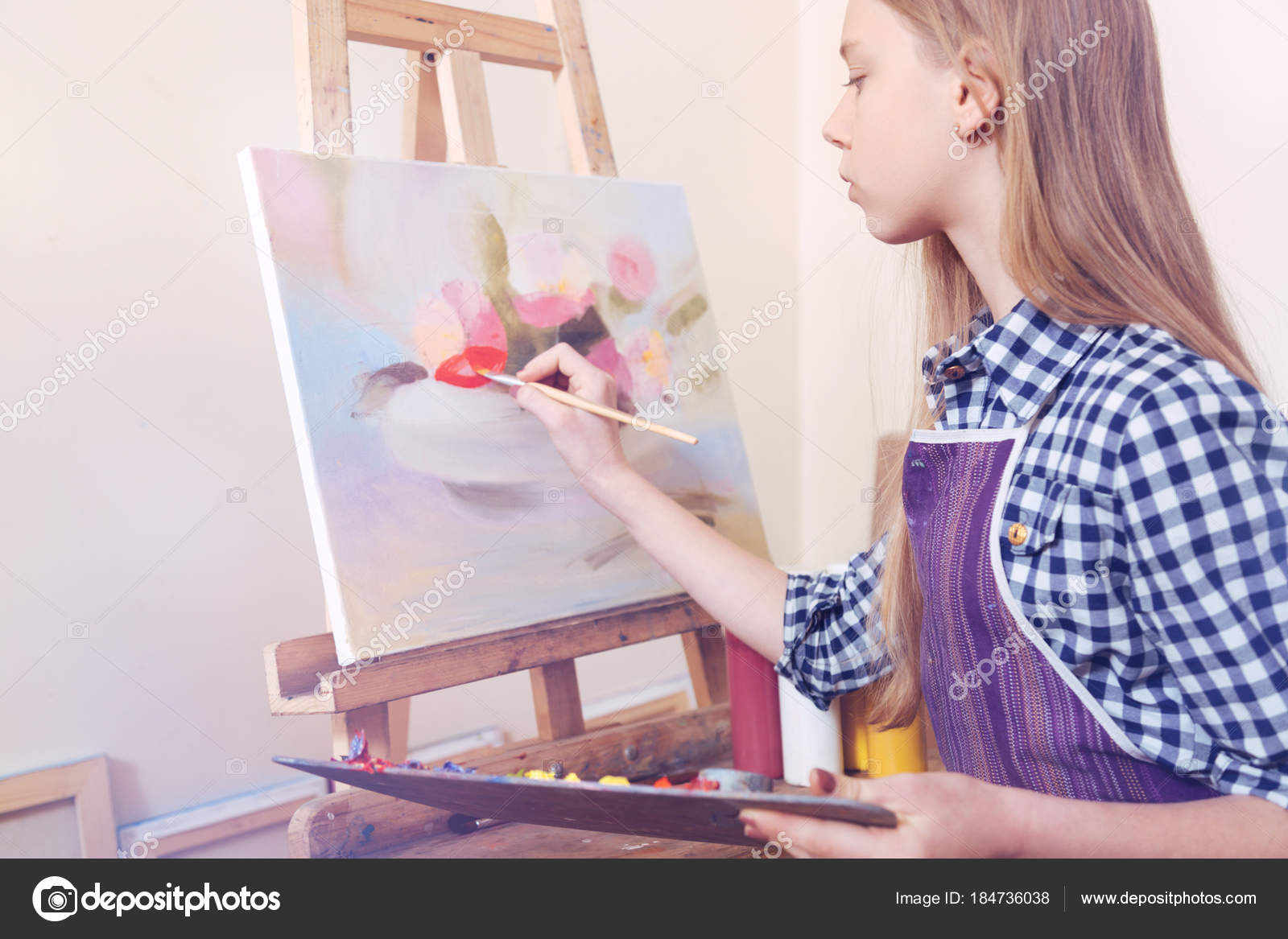 Serious teenage girl creating new masterpiece during workshop Stock ...