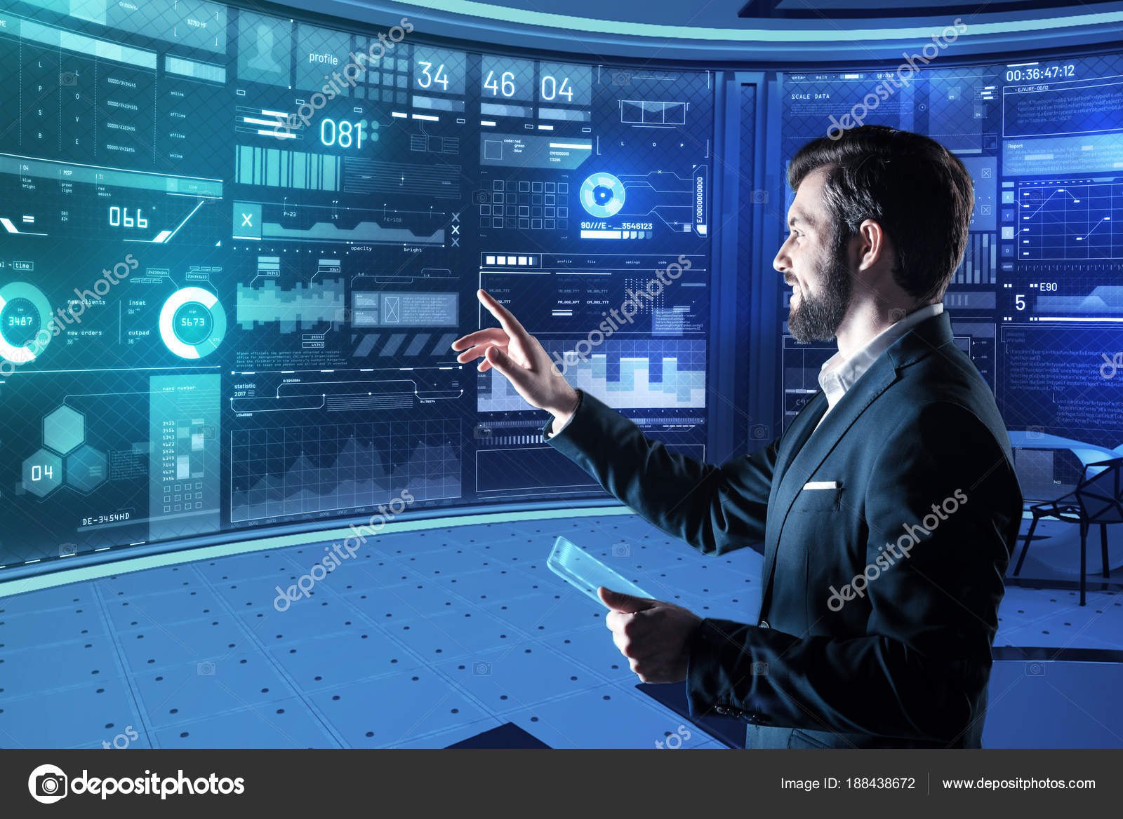 Smiling programmer holding a transparent tablet and pointing to a ...