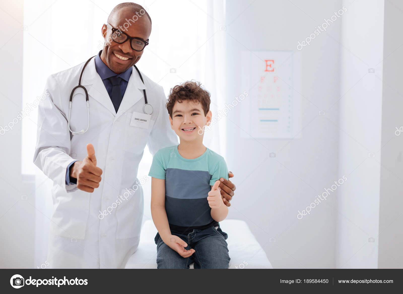 Positive male doctor and boy completing physical exam — Stock Photo ...