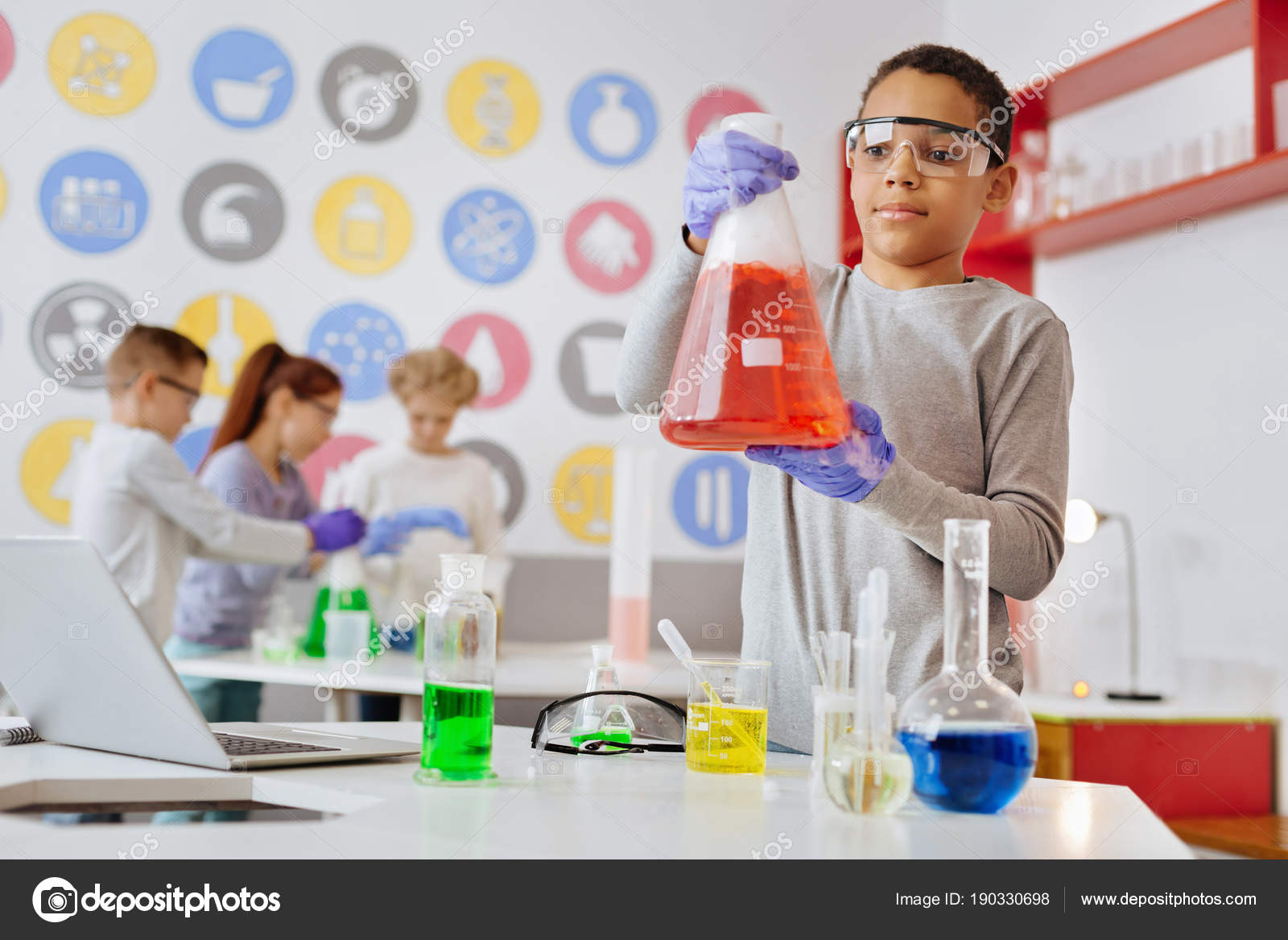 Charming boy observing chemical reaction in the flask — Stock Photo ...