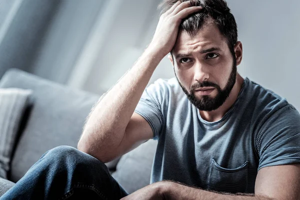 Sad young man being in a difficult situation - Stock Image - Everypixel