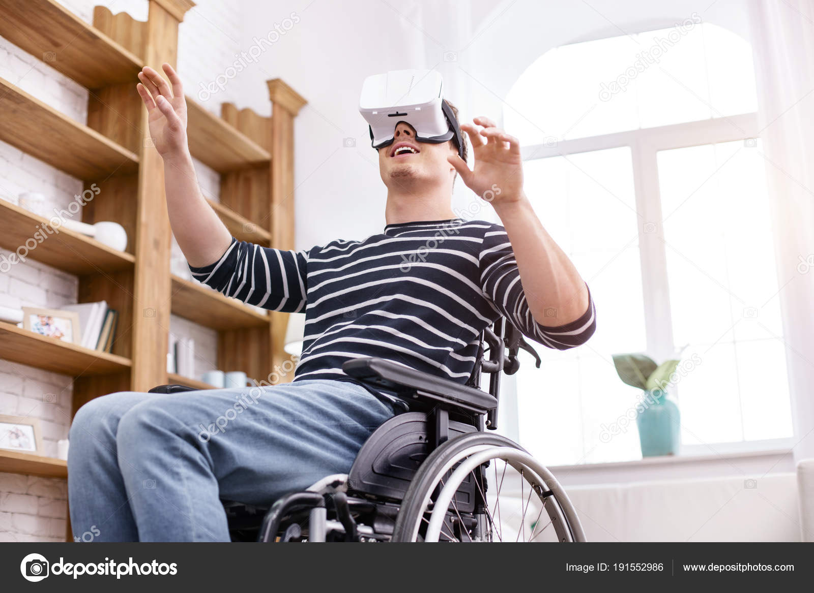 Happy disabled man being glad of his gadget — Stock Photo © yacobchuk1 ...