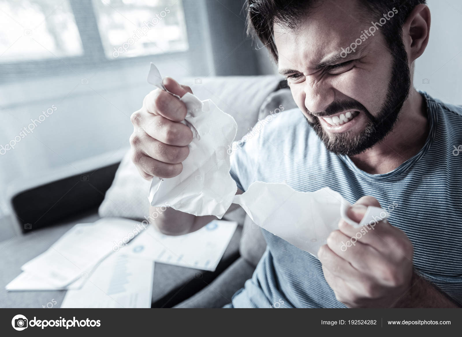 Stressful mad man tearing paper Stock Photo by ©yacobchuk1 192524282