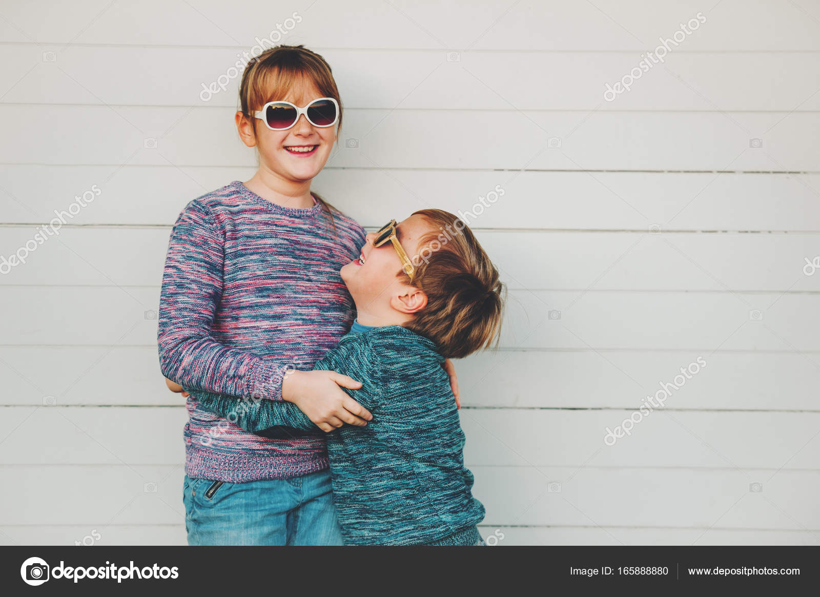 Group of two funny kids playing together outside, little boy and girl ...