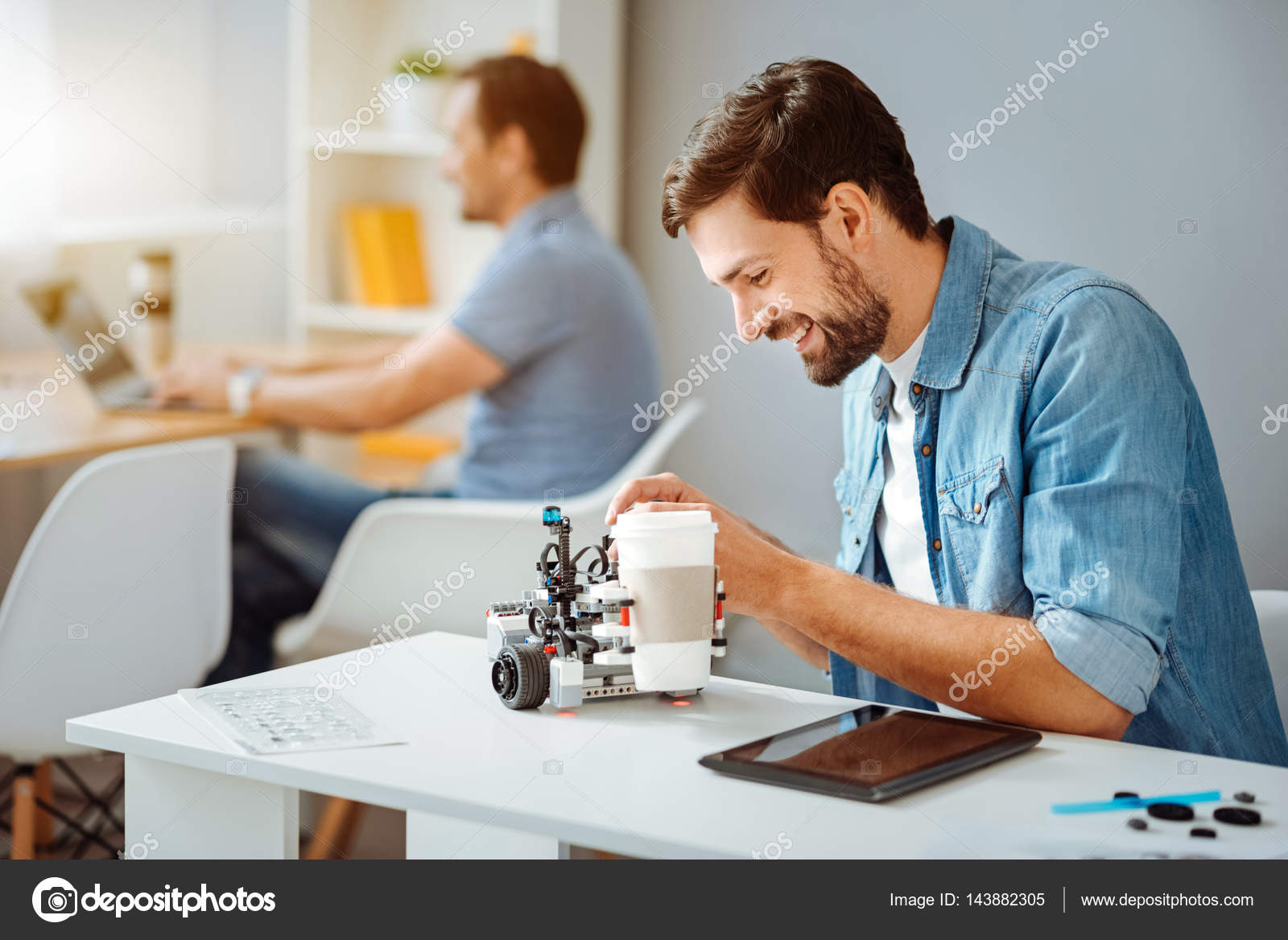 Positive engineer testing the robot Stock Photo by ©Dmyrto_Z 143882305