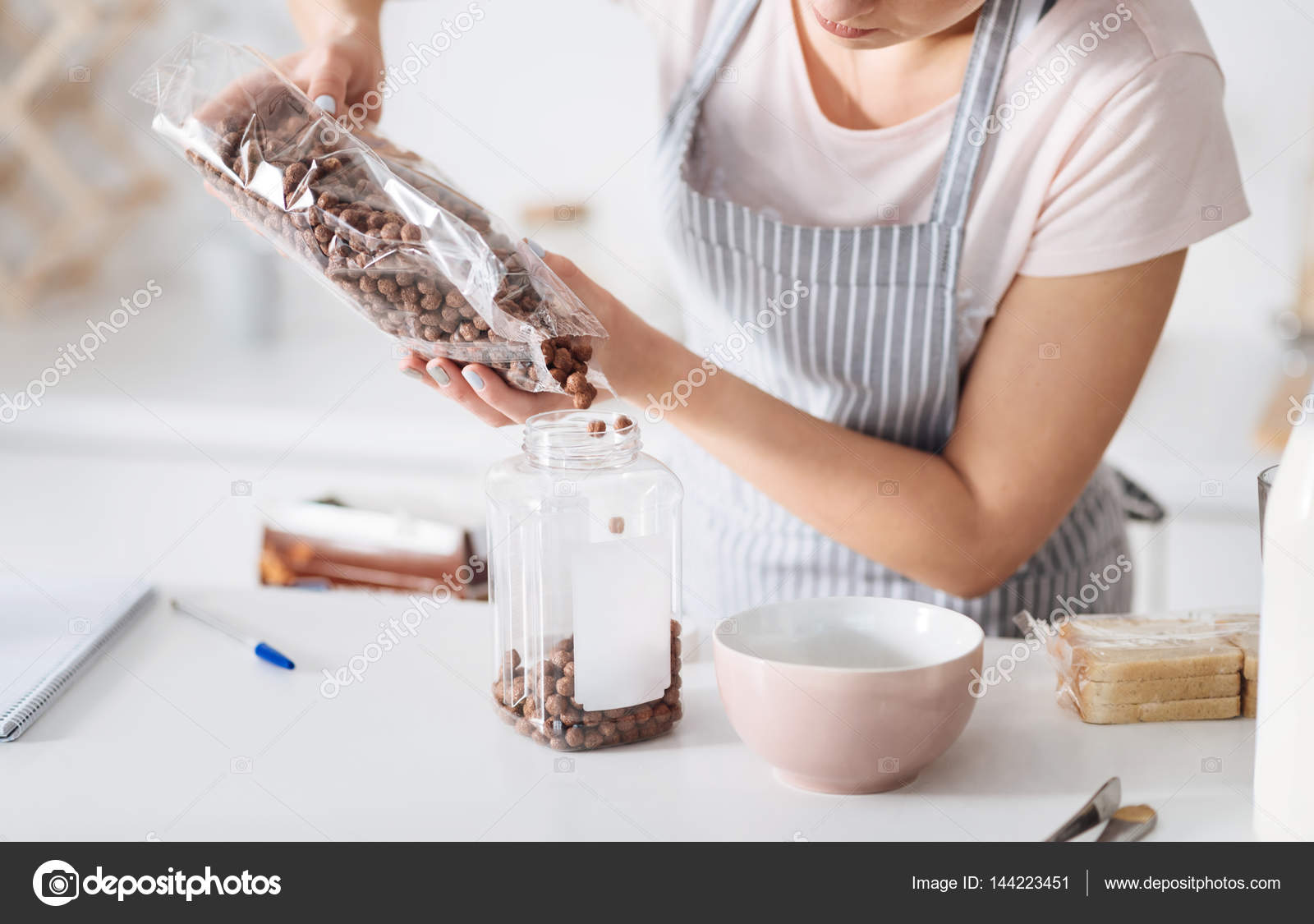 Careful woman filling up a jar — Stock Photo © Dmyrto_Z #144223451