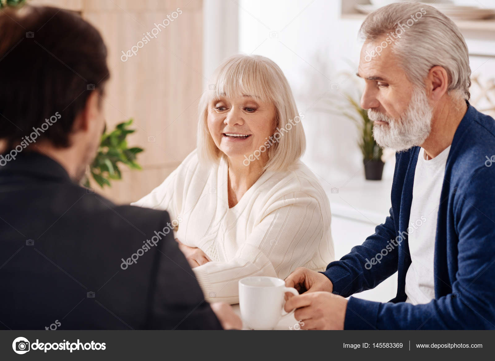 Couple having conversation with advisor Stock Photo by ©Dmyrto_Z 145583369