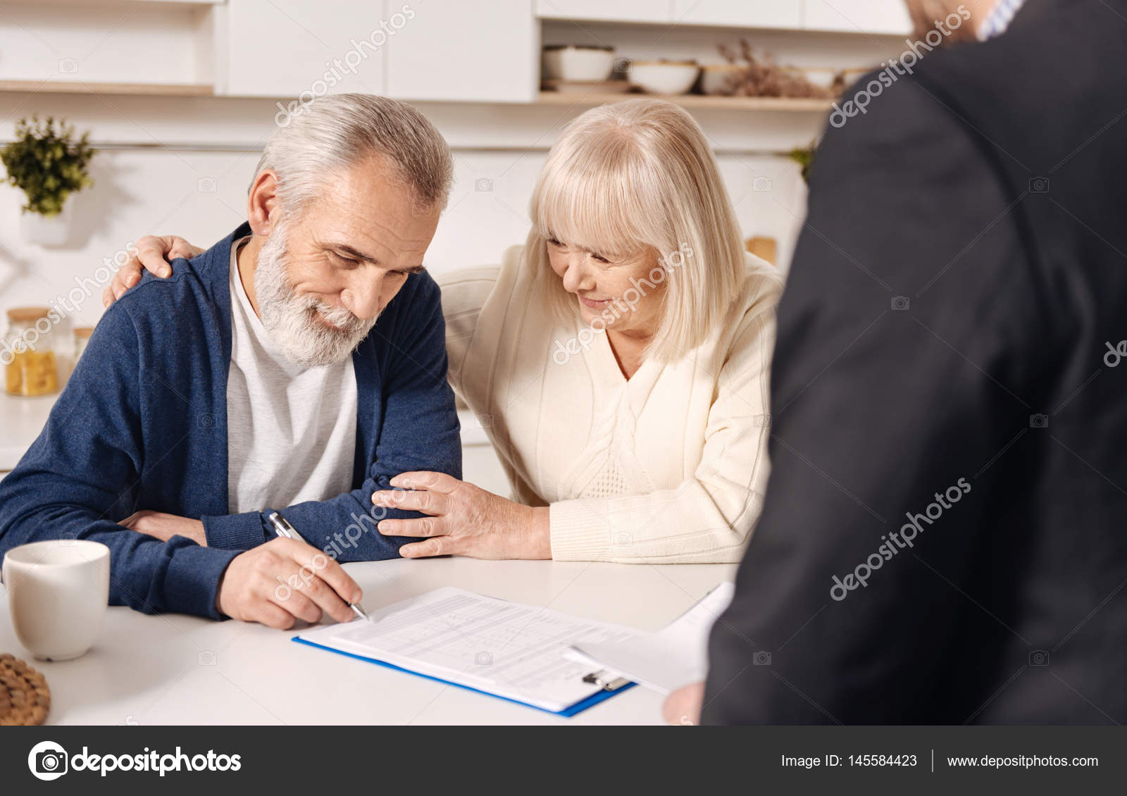 Couple signing documents at home Stock Photo by ©Dmyrto_Z 145584423