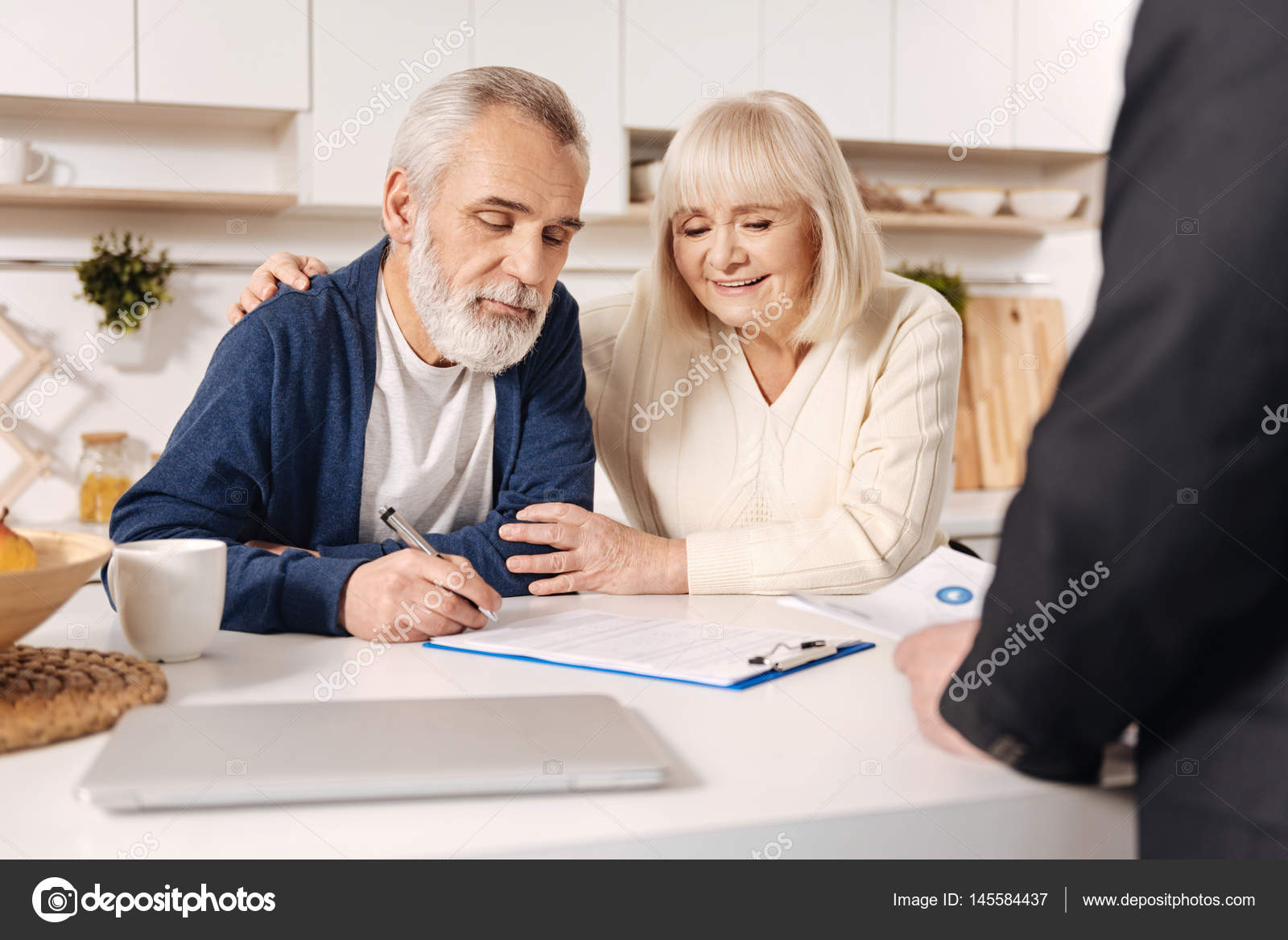 Delightful elderly couple signing documents — Stock Photo © Dmyrto_Z ...