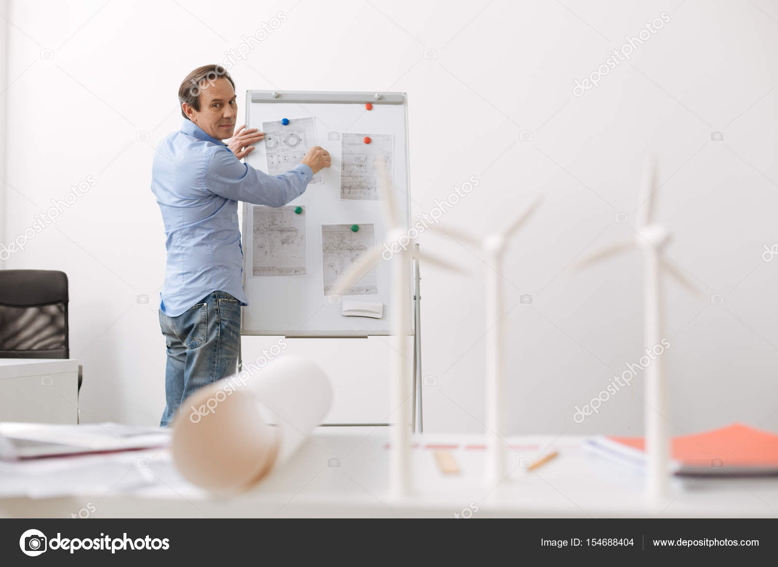 Professional engineer studying schemes of wind turbines Stock Photo by ...