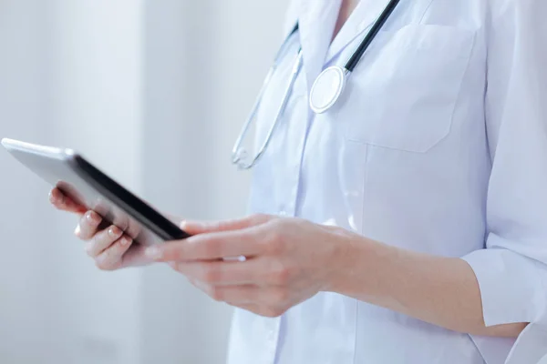 Skillful nurse using electronic gadget at work - Stock Image - Everypixel