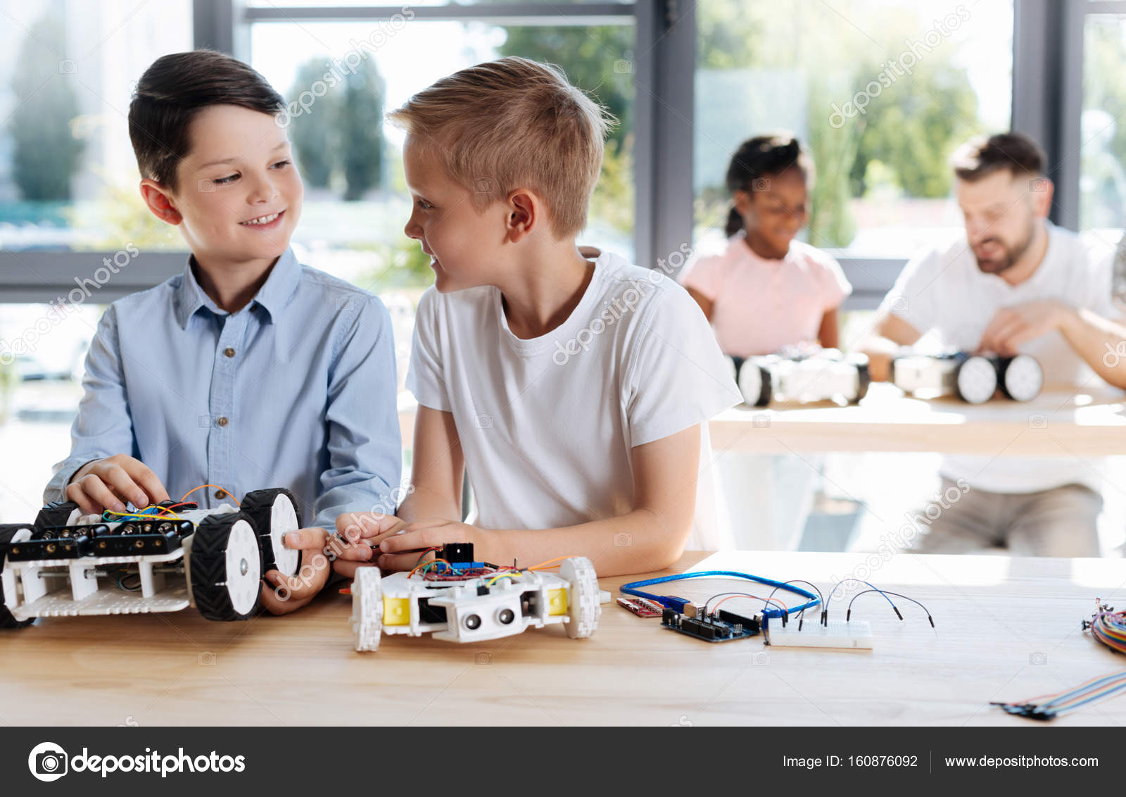Two pre-teen students socializing during robotics class — Stock Photo ...