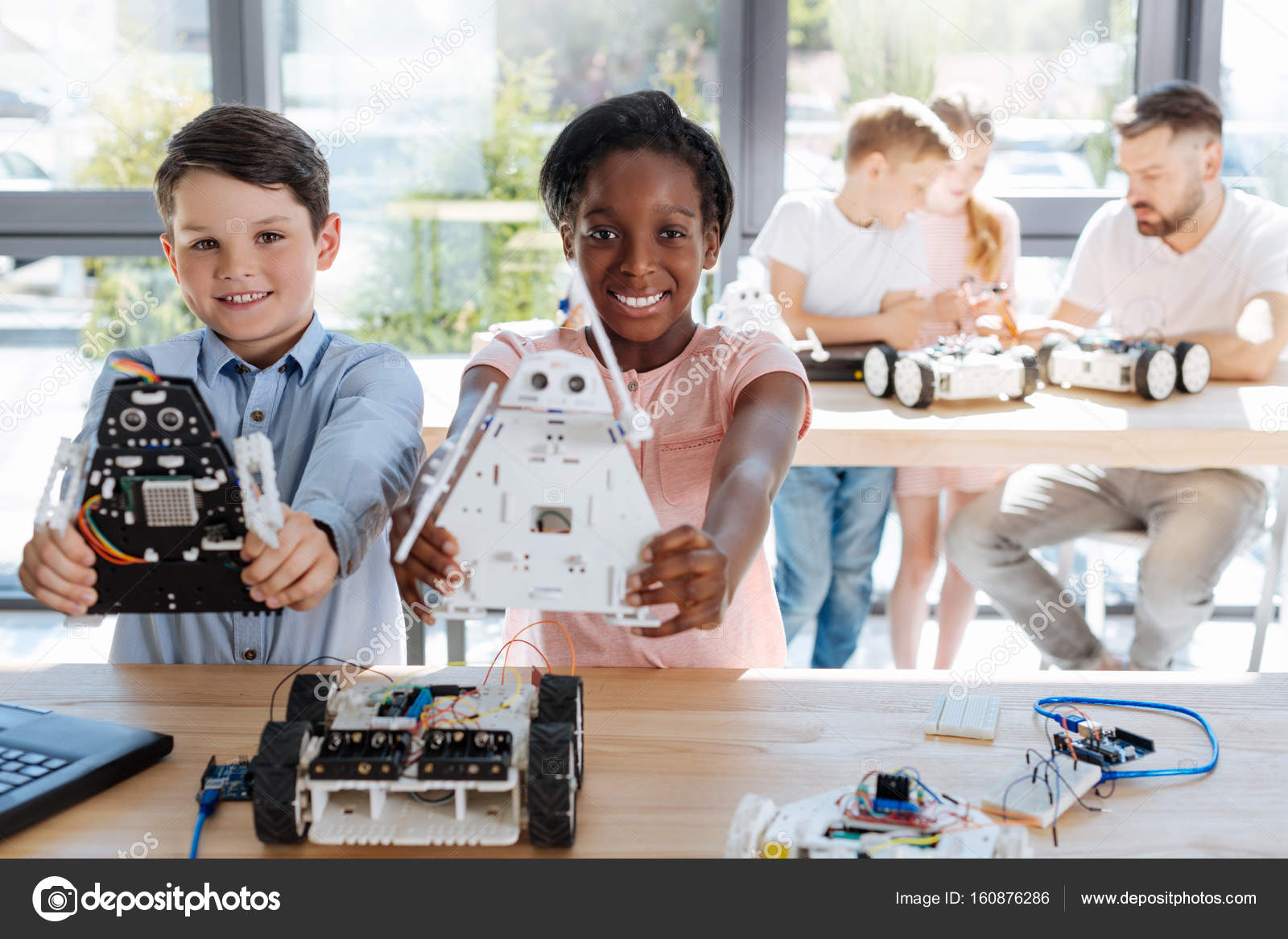 Best friends showing their robot models Stock Photo by ©Dmyrto_Z 160876286