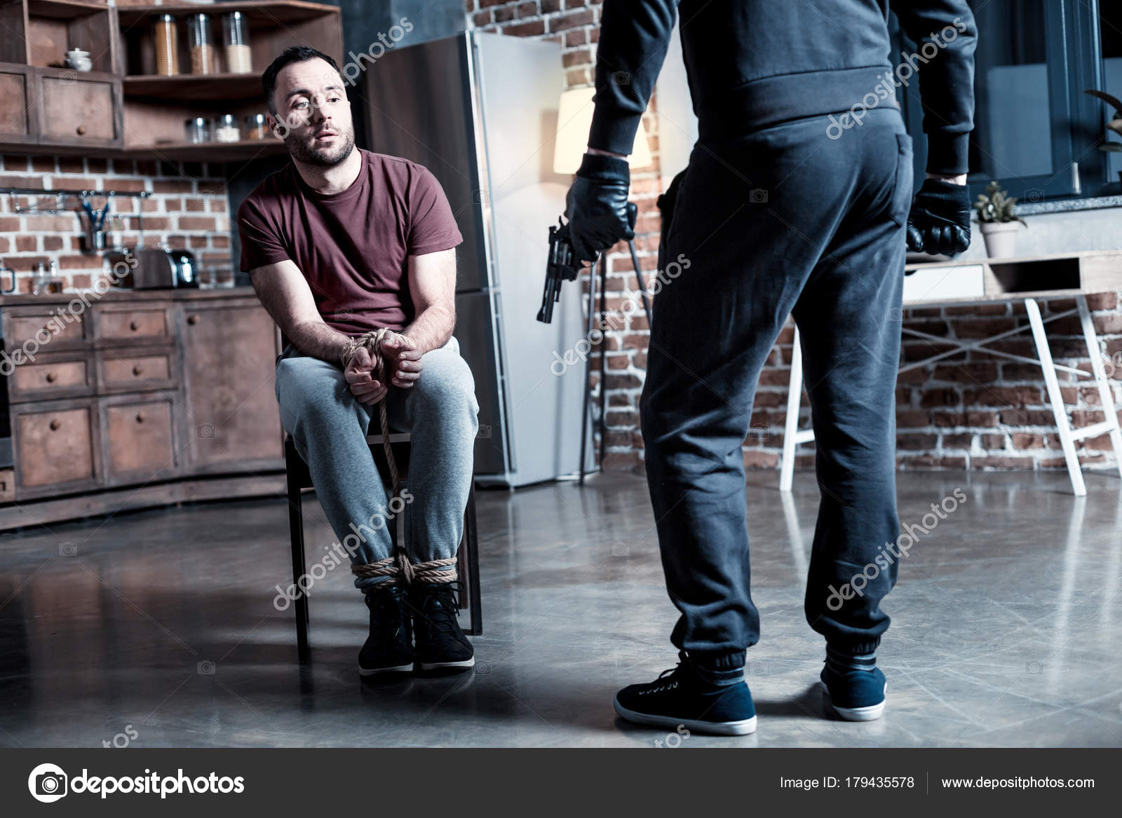 Intimidated man sitting in front of the killer — Stock Photo © Dmyrto_Z ...