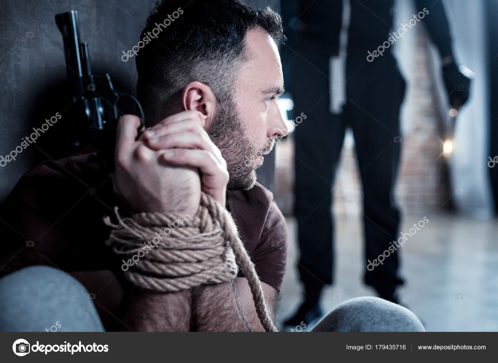 Shocked man hiding from a robber with his hands tied Stock Photo by ...