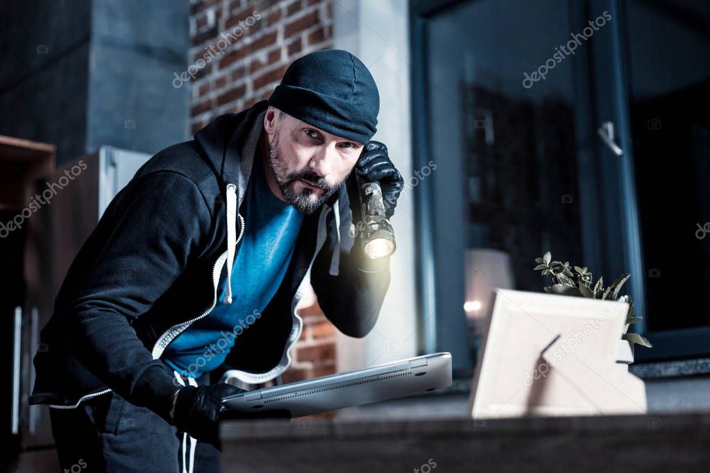 Concentrated bearded thief stealing a laptop — Stock Photo © Dmyrto_Z ...